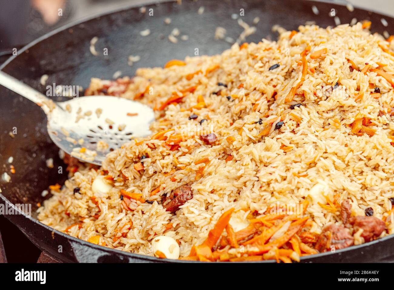 Cooking delicious pilaf, traditional Central Asian cuisine Stock Photo ...