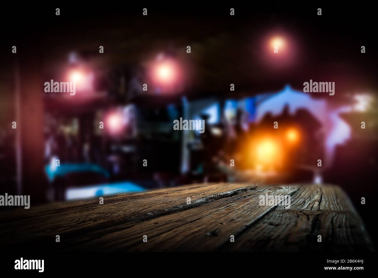 Dark blurred background of bar restaurant and old brown wooden table ...