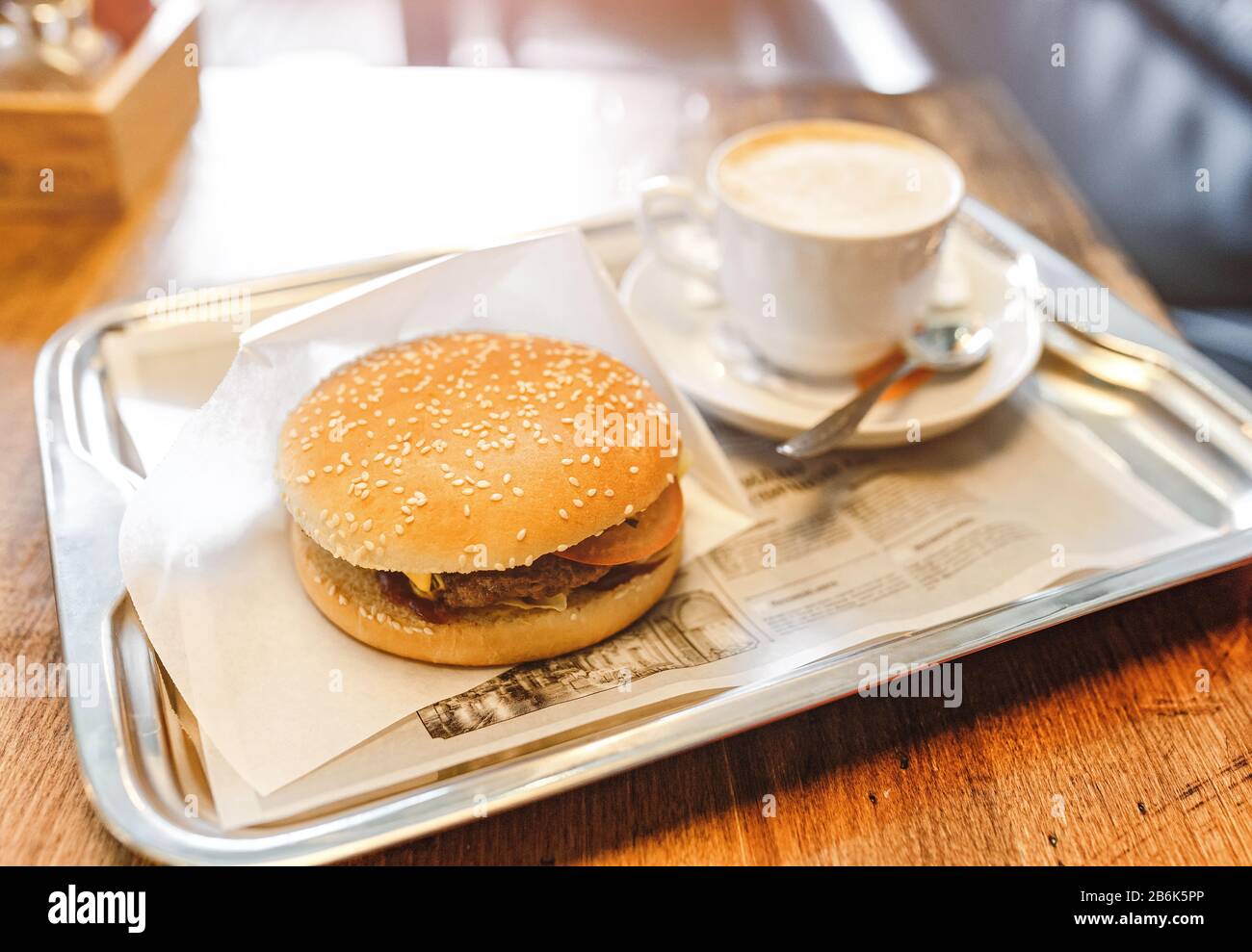 Tasty burger and cup of coffee on a tray in fast food cafe Stock Photo ...