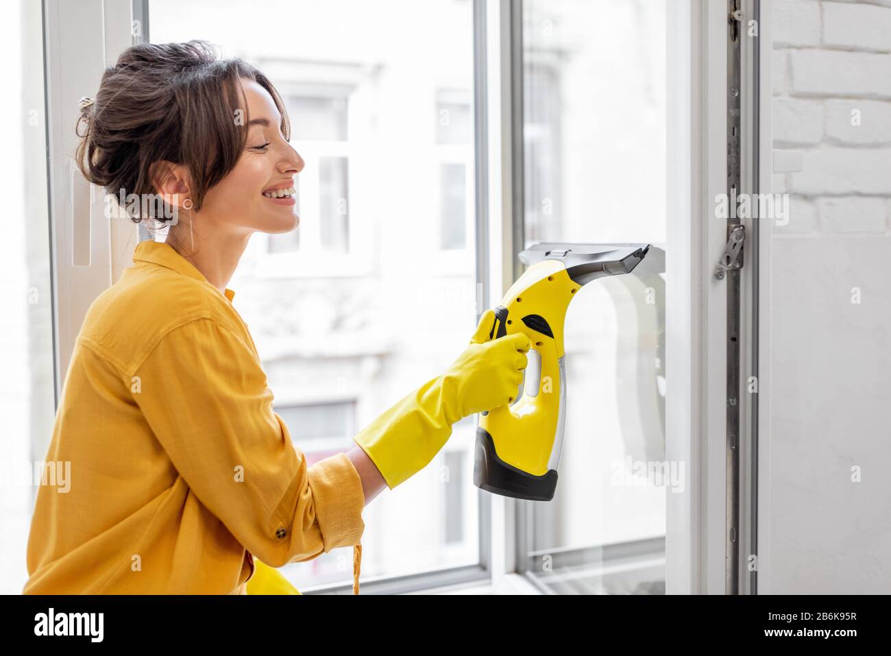 Young woman washing windows hi-res stock photography and images - Alamy