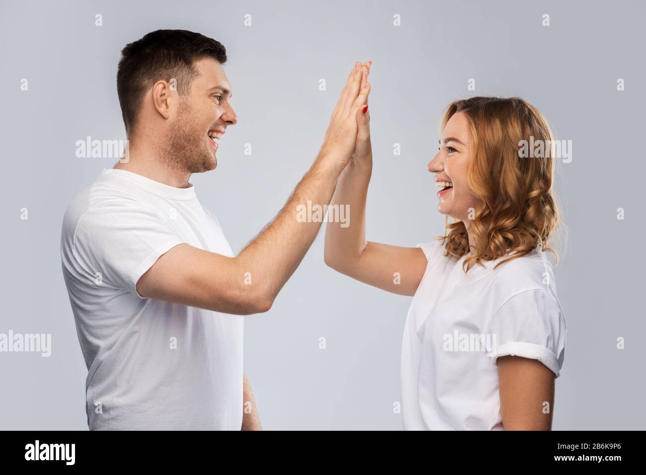 happy couple making high five gesture Stock Photo - Alamy