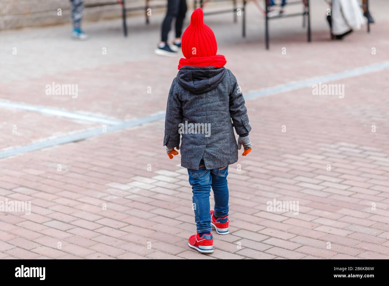 Cute boy kid in fashionable coat and hat rear view Stock Photo - Alamy