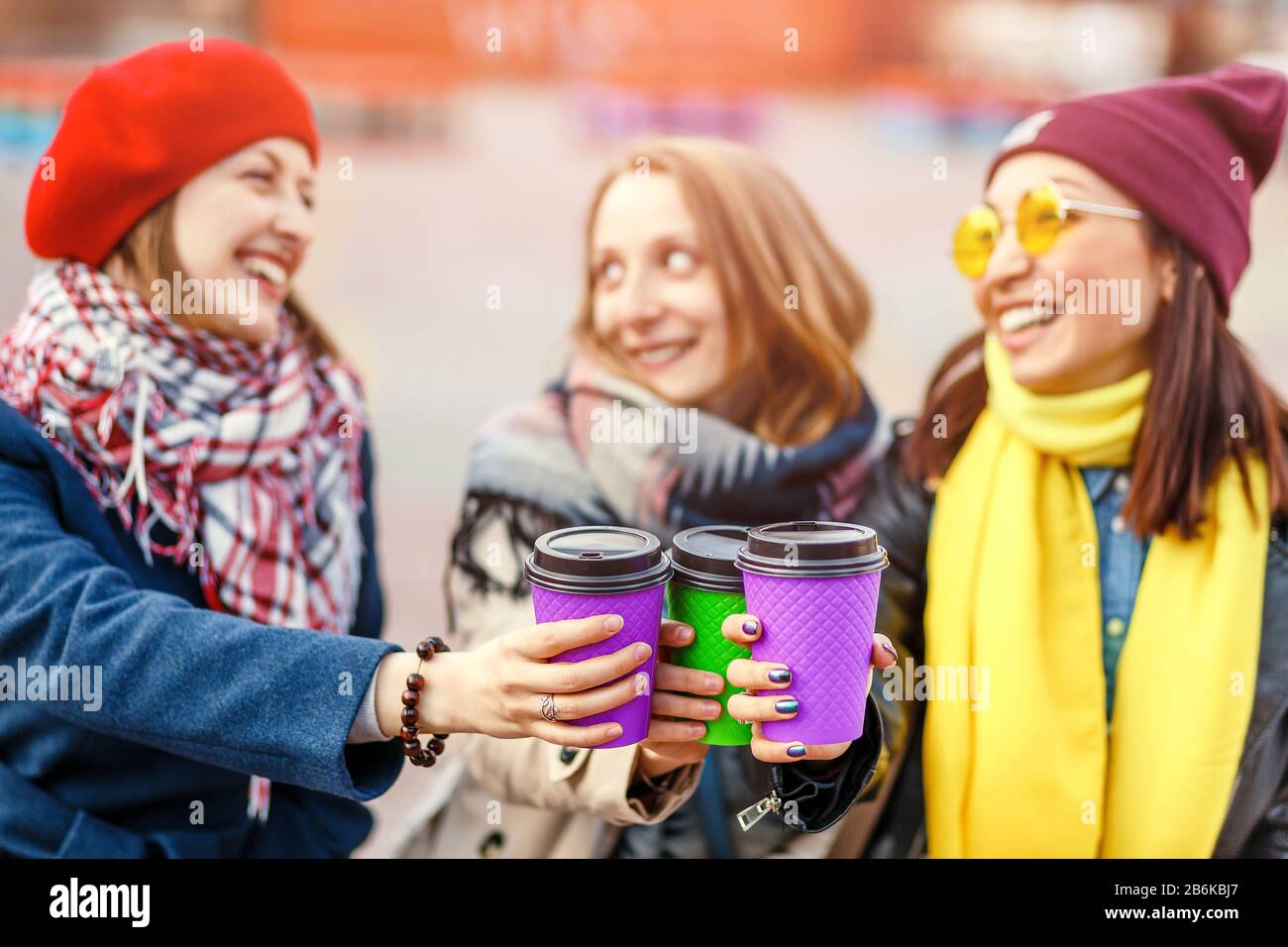 Three friends talking and having fun while drinking coffee hi-res stock ...