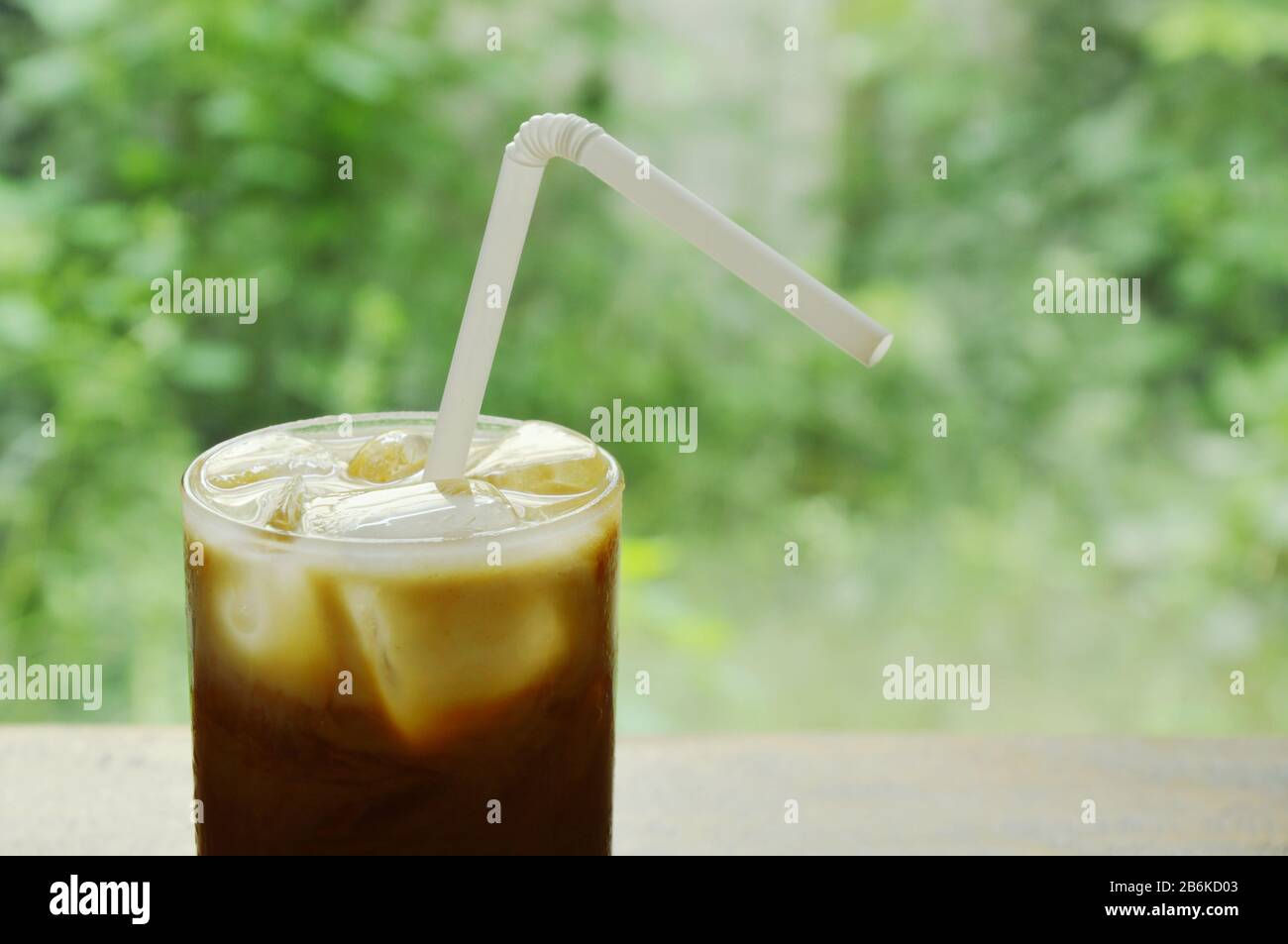 ice coffee topping milk floating with straw in glass Stock Photo - Alamy