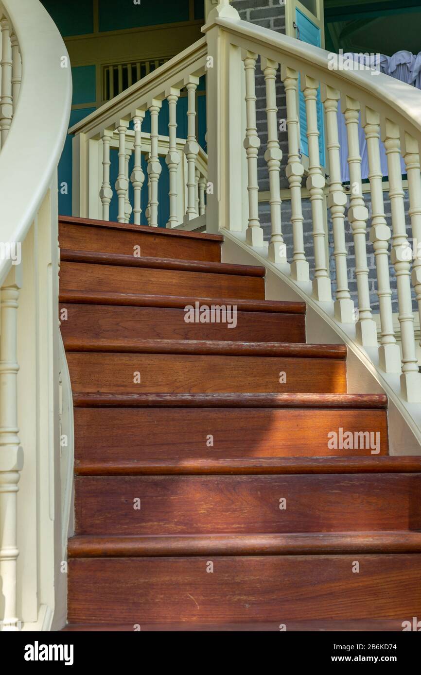 Close up of Vintage wooden staircase railing. An elegant antique spiral ...