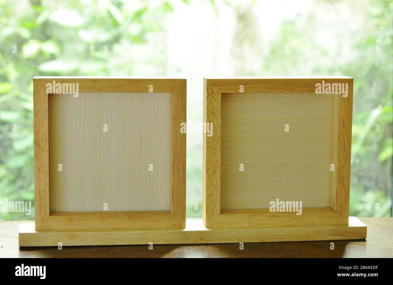 wooden picture frame on table with garden background Stock Photo - Alamy