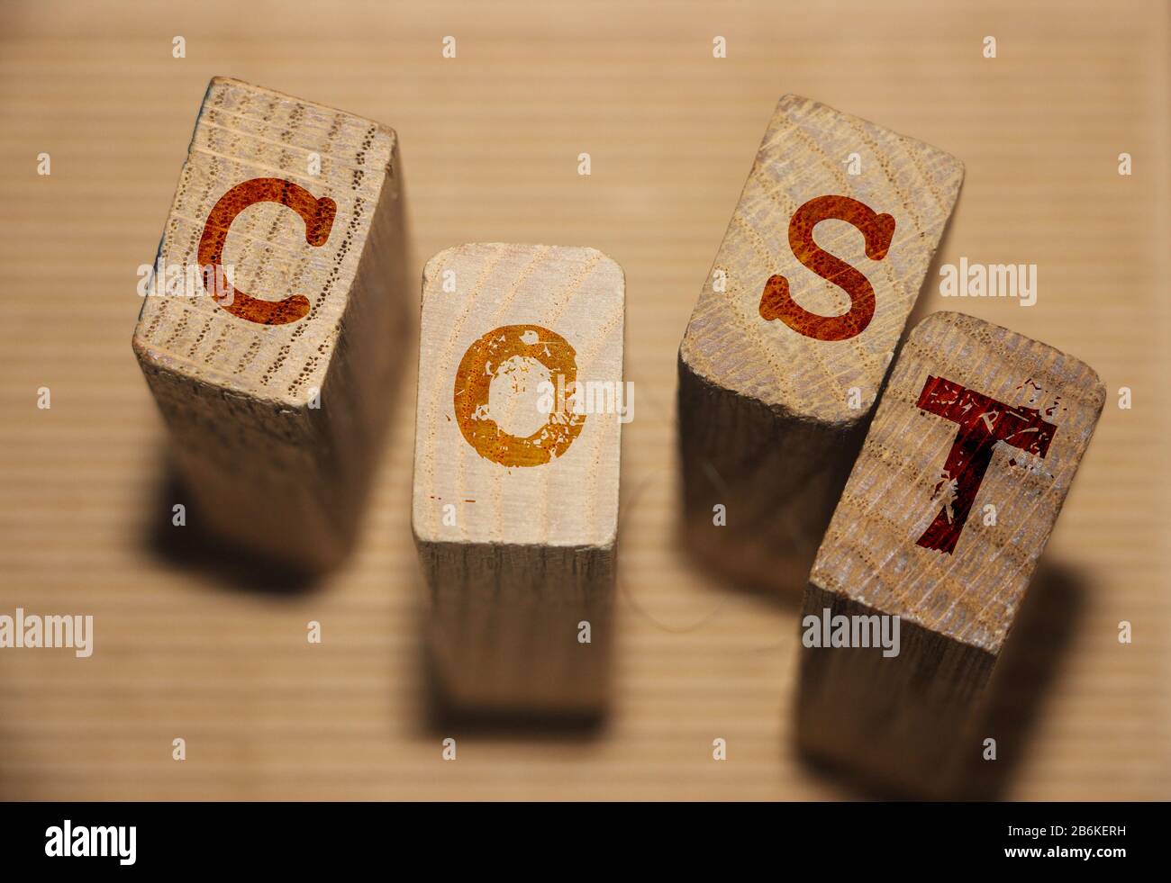 Wooden block with alphabet combine word COST, Cost, expense or company ...
