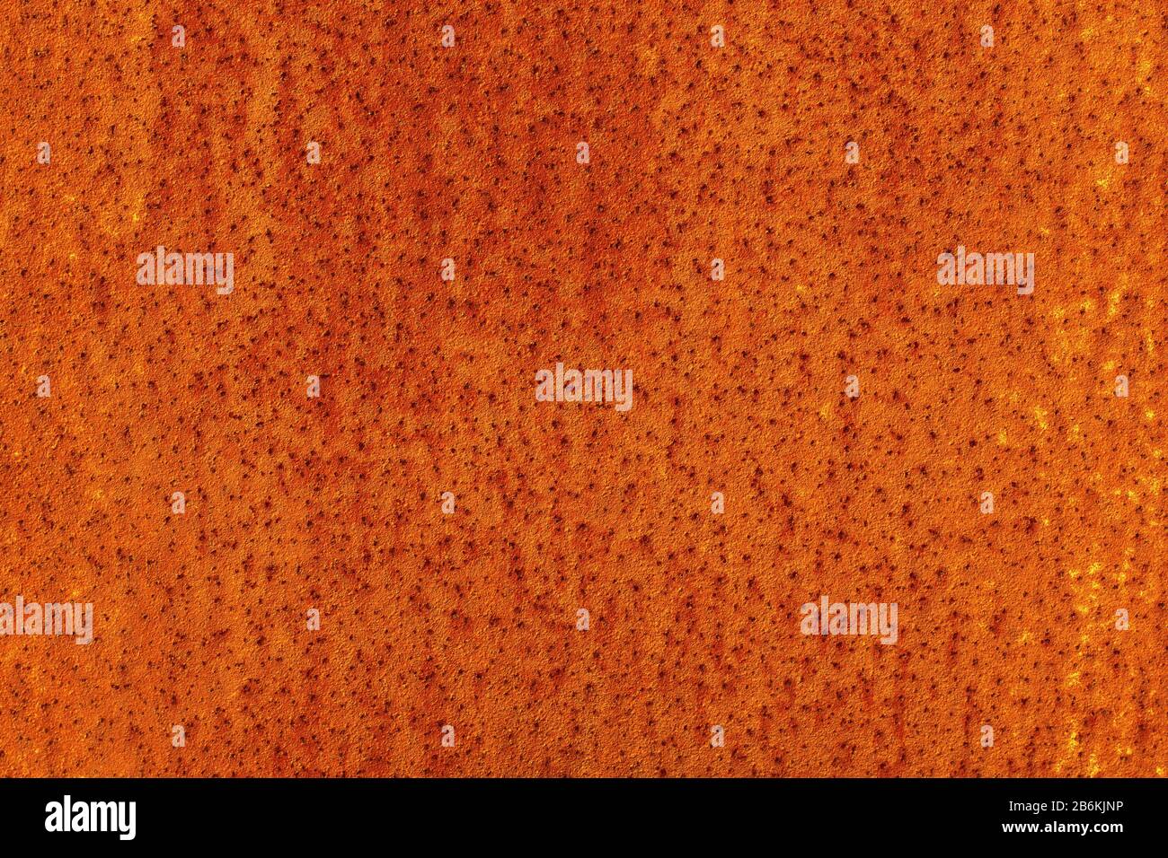 The surface of an old rusty sheet of metal with small dots. Abstract ...