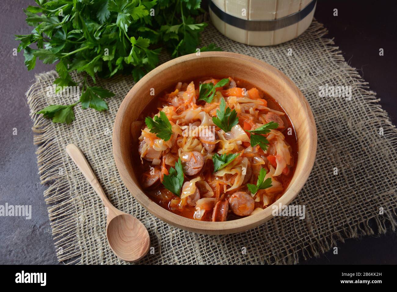 Cabbage stew with grilled sausage in tomato sauce - traditional dish of ...