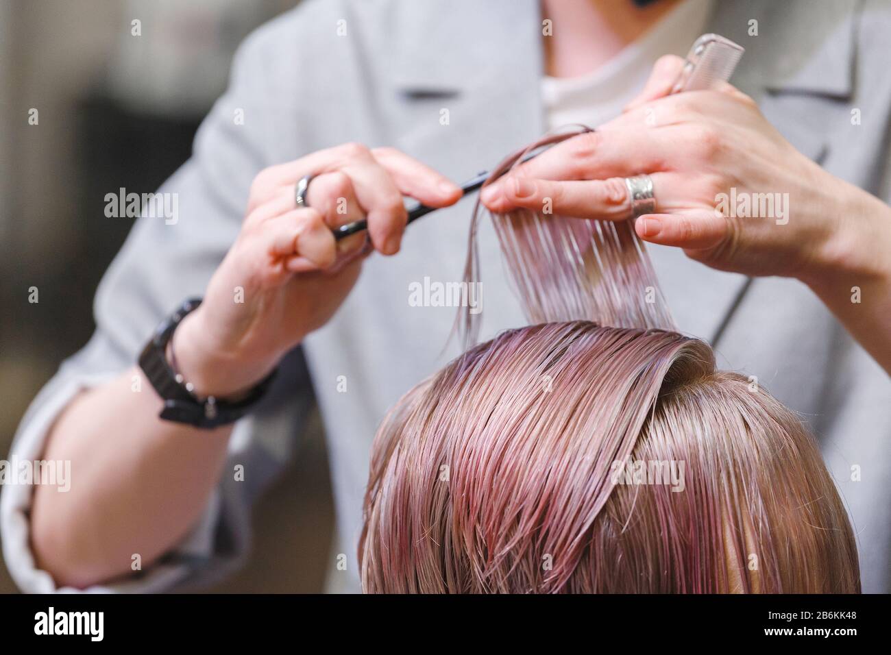 Close-up of a hairdresser woman cutting hair in beauty salon Stock ...