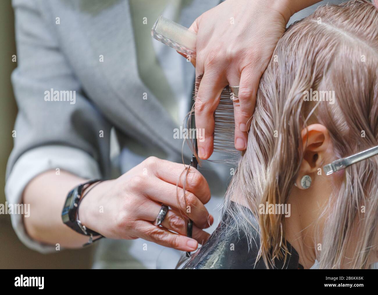 Close-up of a hairdresser woman cutting hair in beauty salon Stock ...