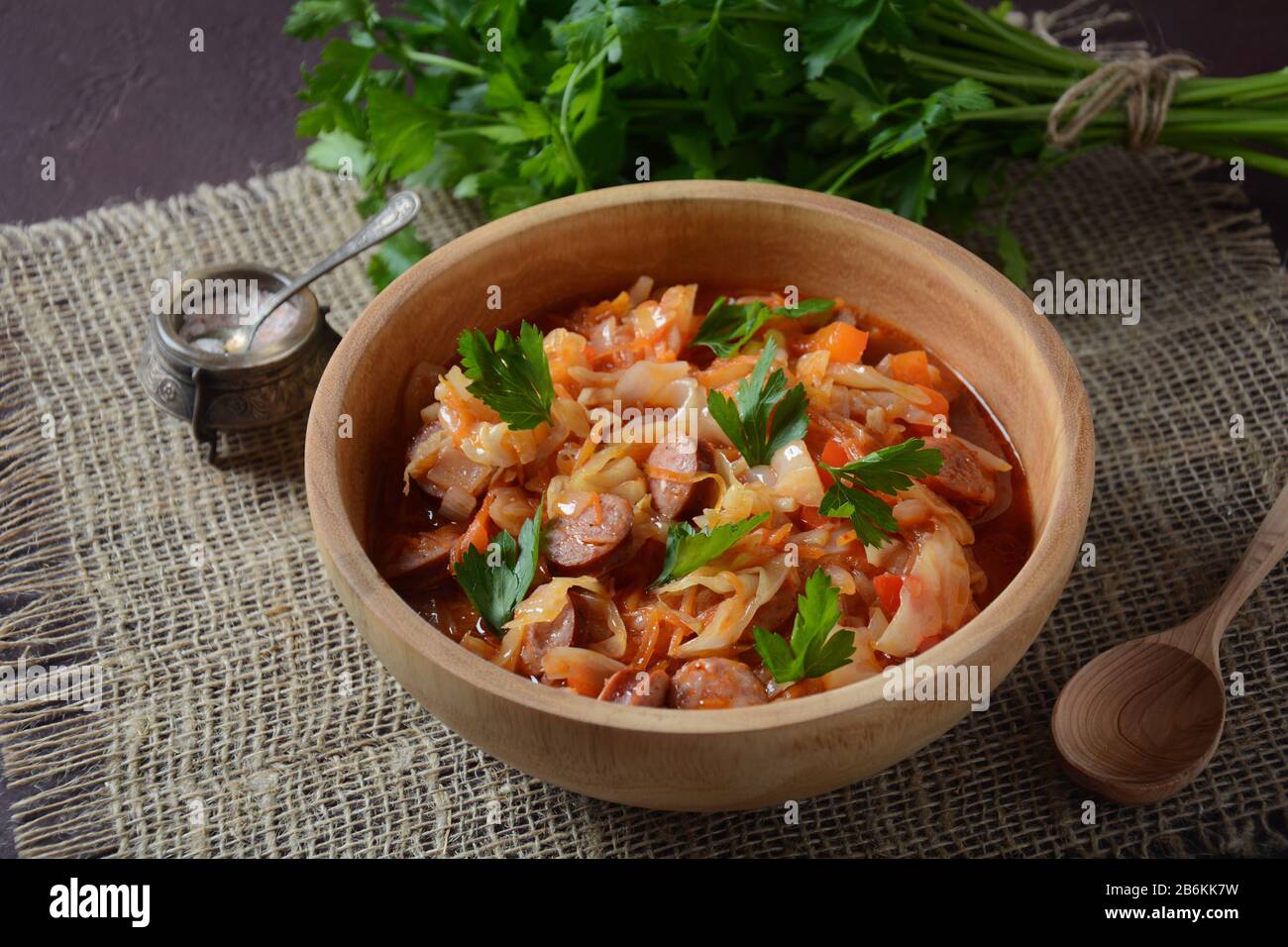 Cabbage stew with grilled sausage in tomato sauce - traditional dish of ...