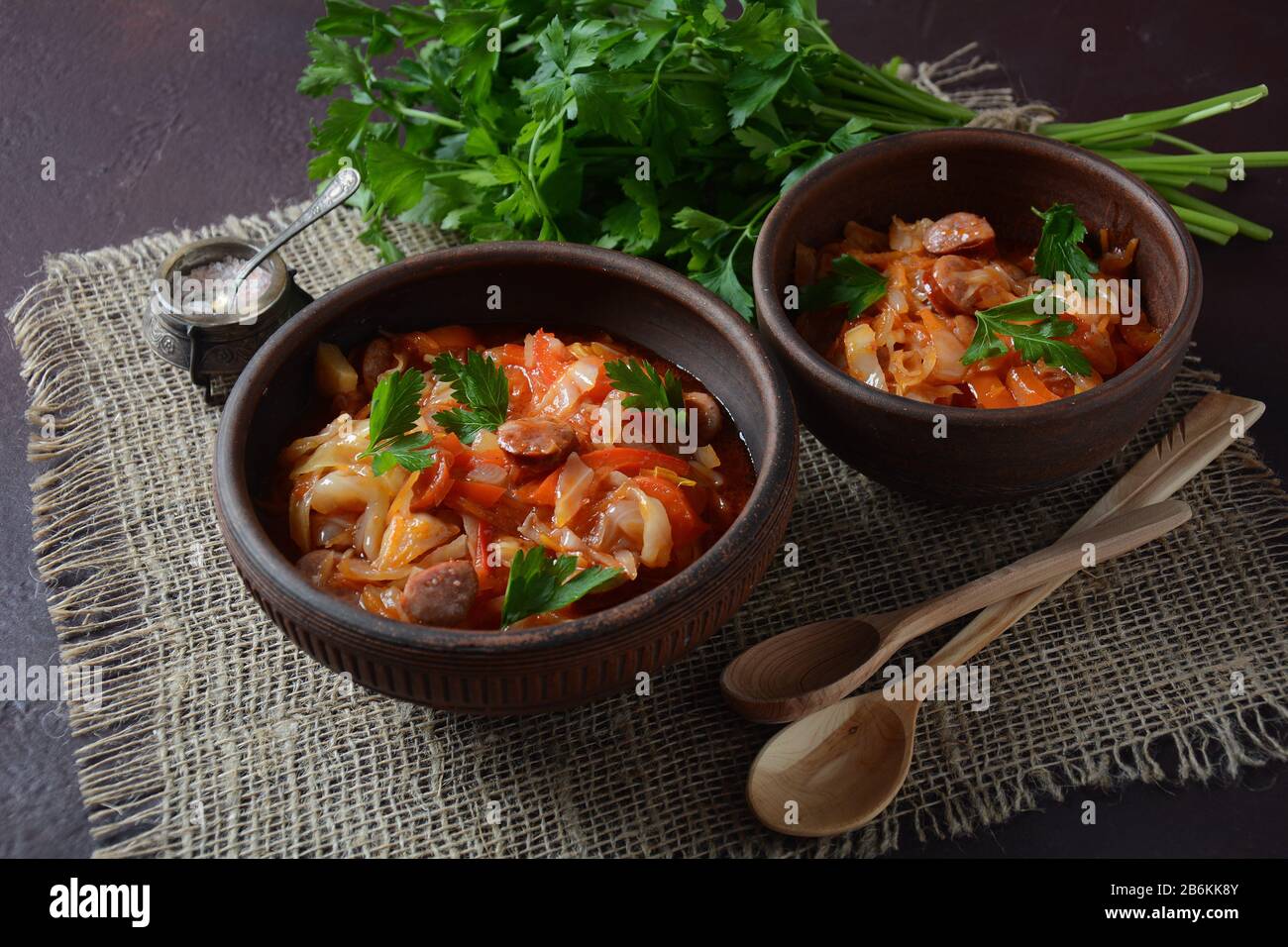Cabbage stew with grilled sausage in tomato sauce - traditional dish of ...