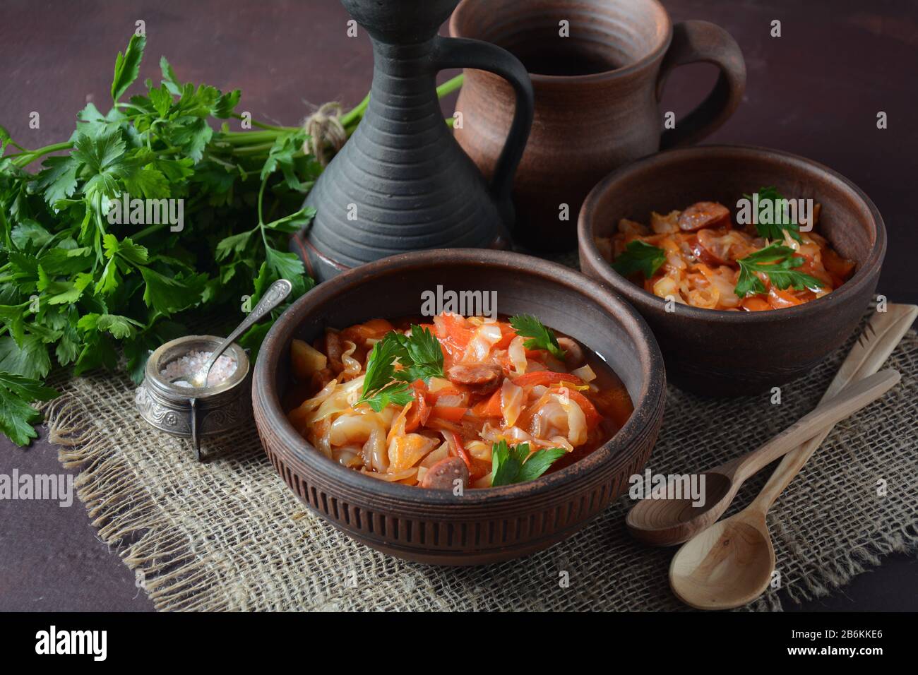 Cabbage stew with grilled sausage in tomato sauce - traditional dish of ...