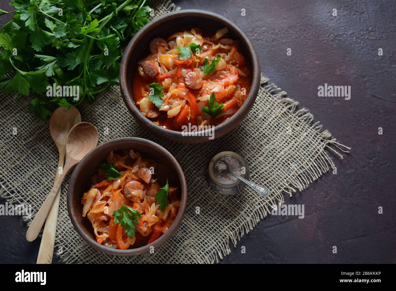 Cabbage stew with grilled sausage in tomato sauce - traditional dish of ...
