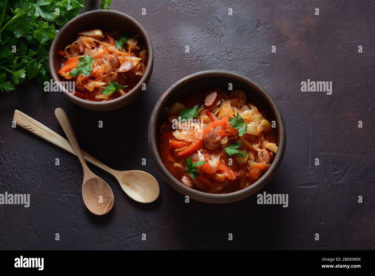 Cabbage stew with grilled sausage in tomato sauce - traditional dish of ...