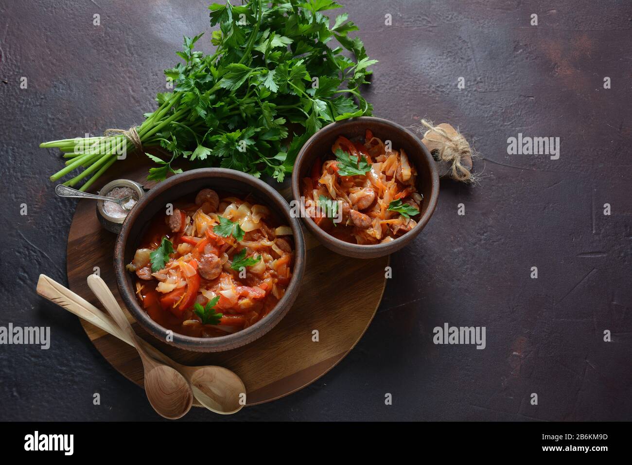 Cabbage stew with grilled sausage in tomato sauce - traditional dish of ...