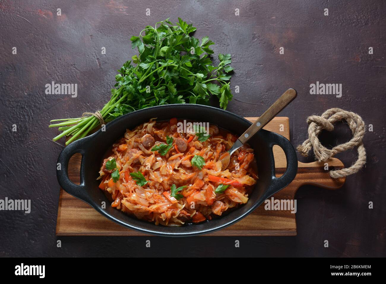 Cabbage stew with grilled sausage in tomato sauce - traditional dish of ...