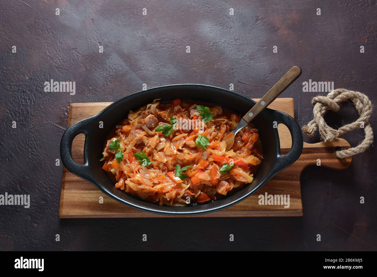 Cabbage stew with grilled sausage in tomato sauce - traditional dish of ...