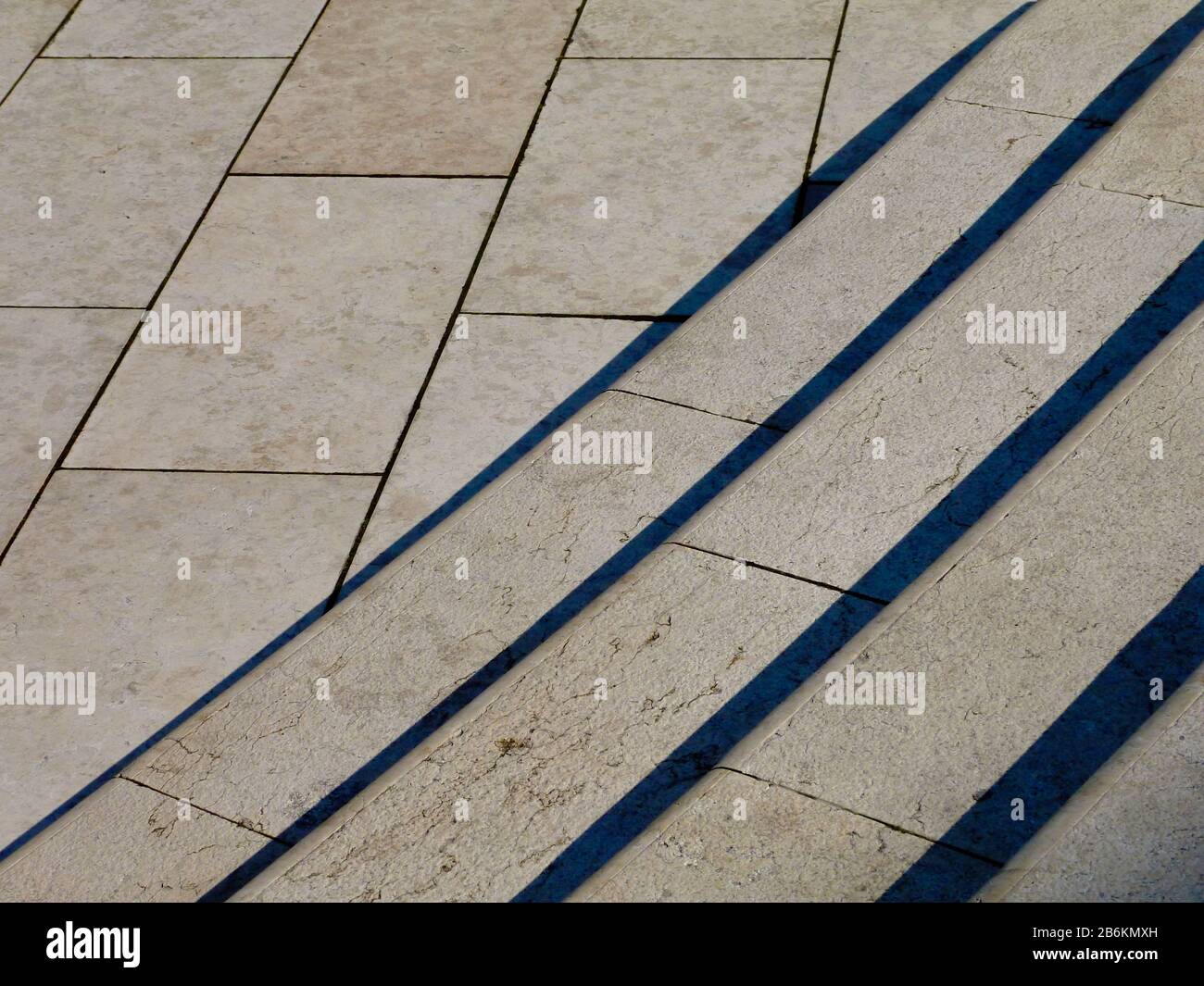 White stone stairs. curved shape. bright daylight with shadows bullnose ...