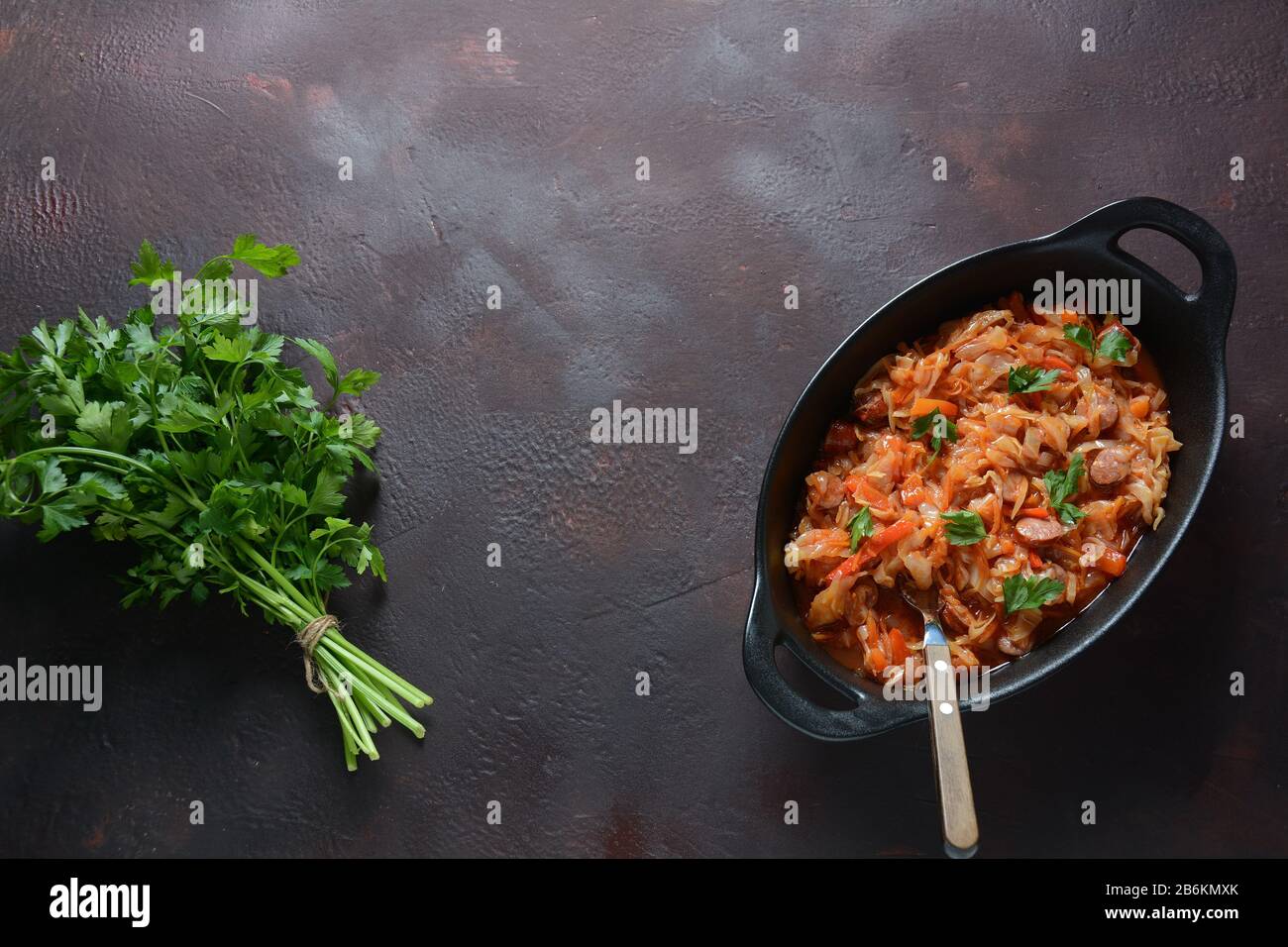 Cabbage stew with grilled sausage in tomato sauce - traditional dish of ...