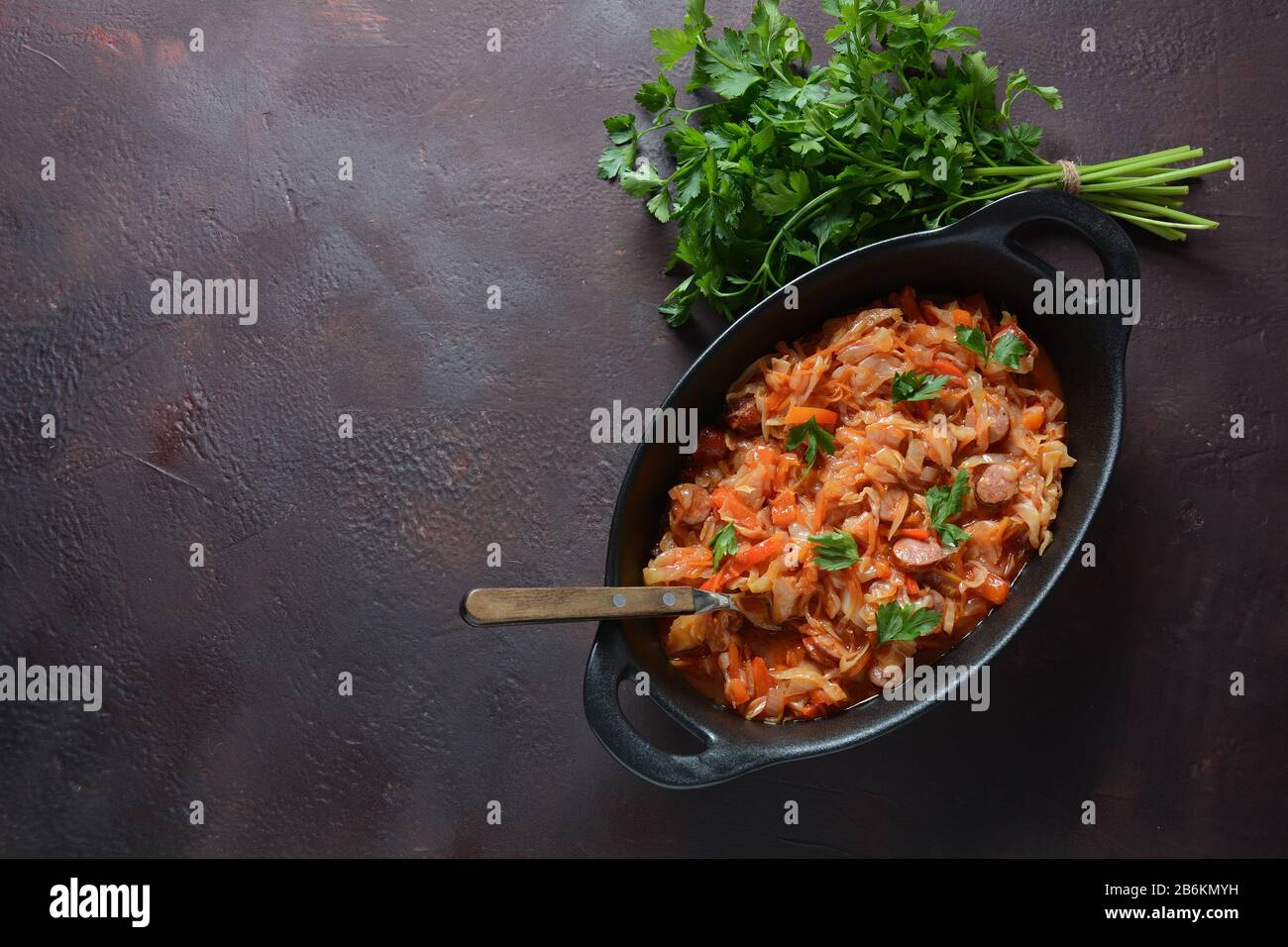 Cabbage stew with grilled sausage in tomato sauce - traditional dish of ...