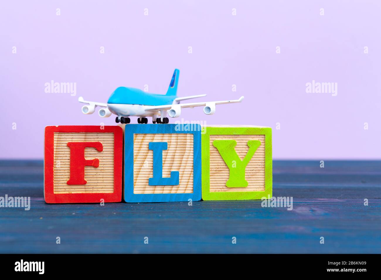 cube wooden block with alphabet building the word fly Stock Photo - Alamy