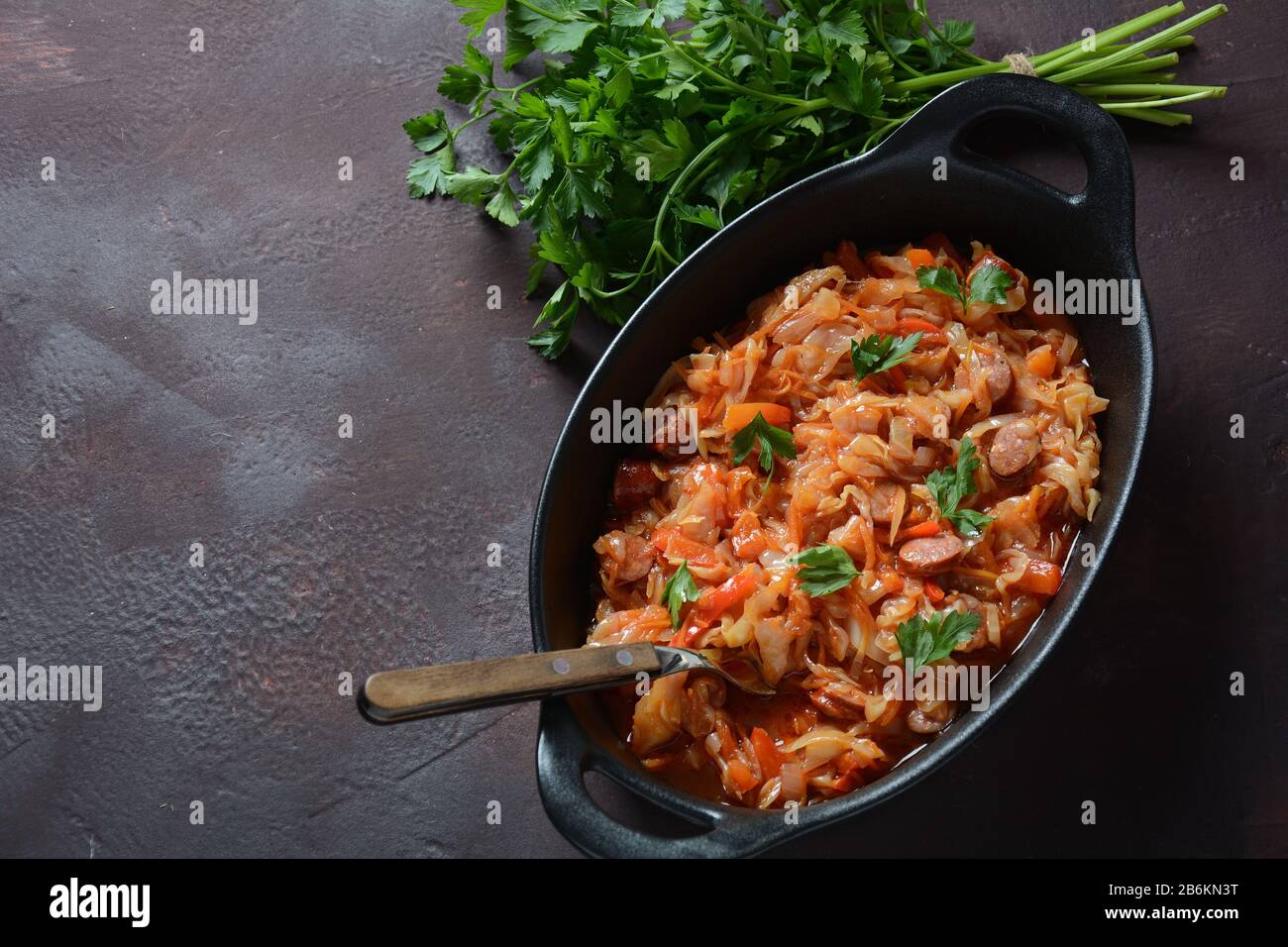 Cabbage stew with grilled sausage in tomato sauce - traditional dish of ...