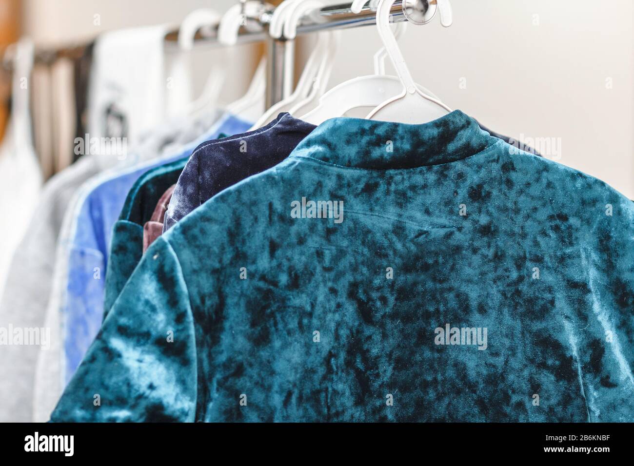 a hanging velvet and velour clothes on a rack Stock Photo - Alamy