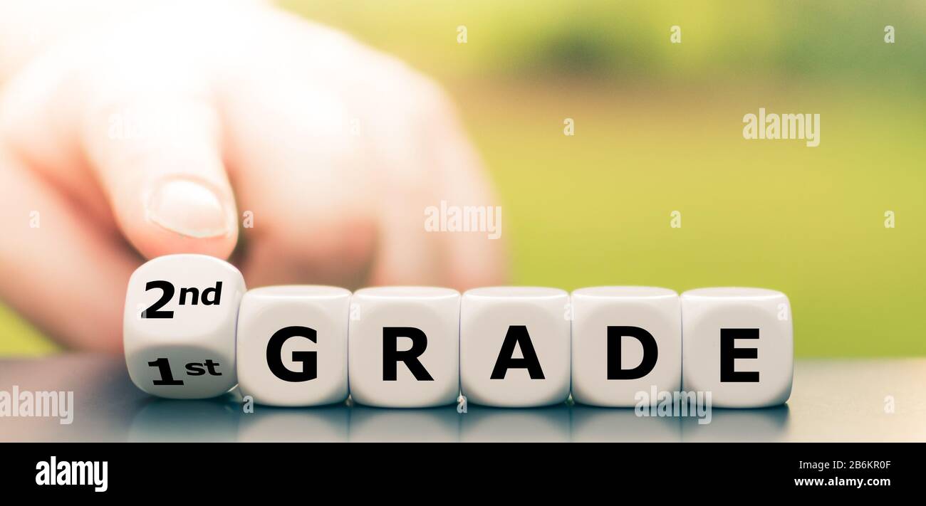 Hand turns dice and changes the expression "1st grade" to "2nd grade ...