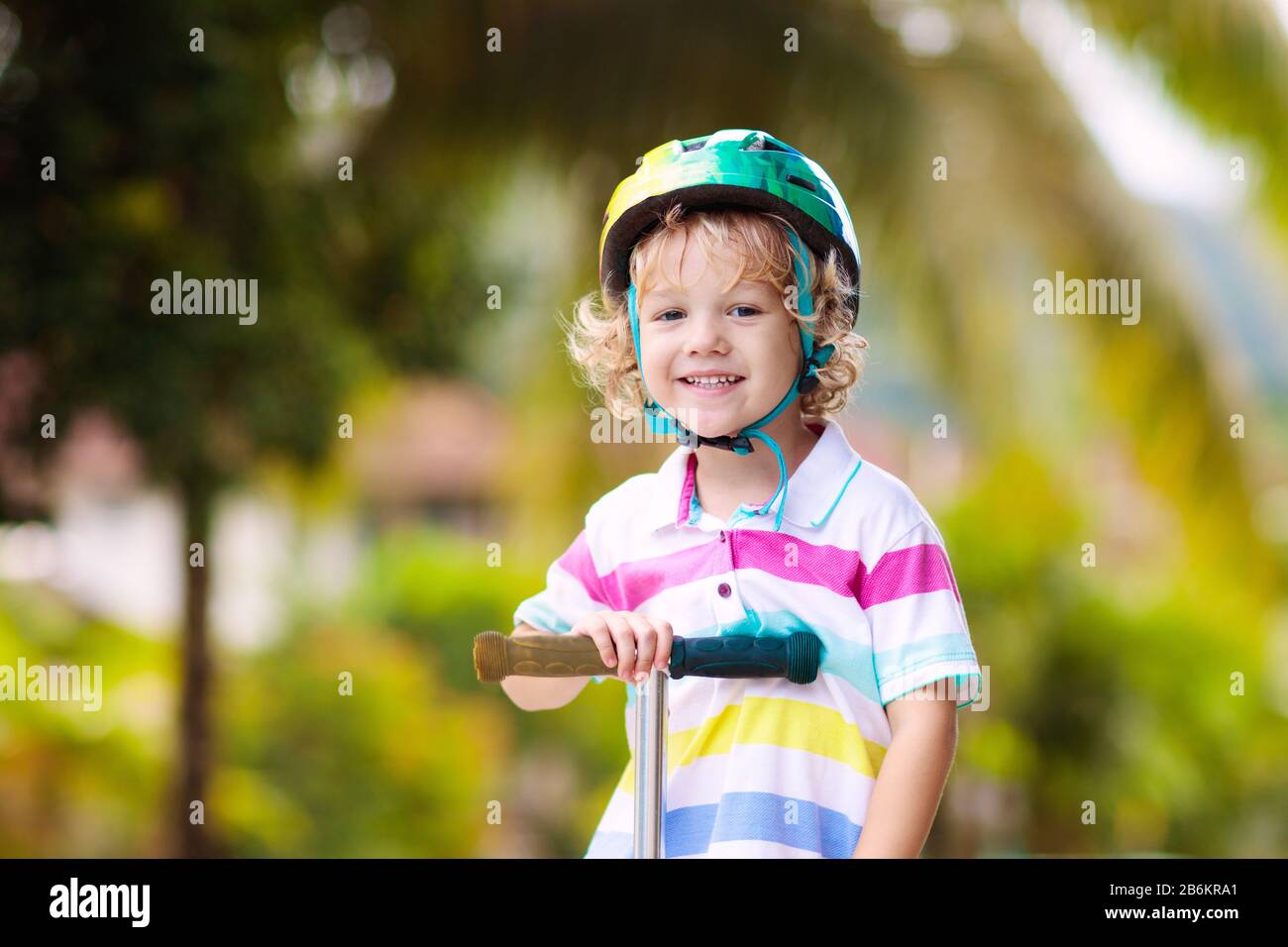 Little boy riding scooter. Kids ride kick board. Child playing on ...