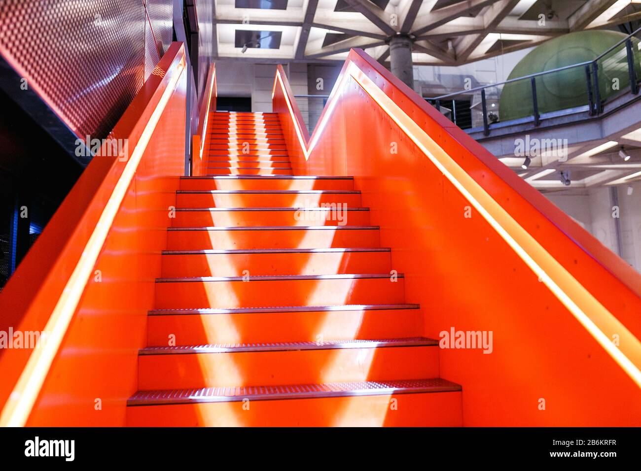 Orange steel stairway indoors in modern building Stock Photo - Alamy
