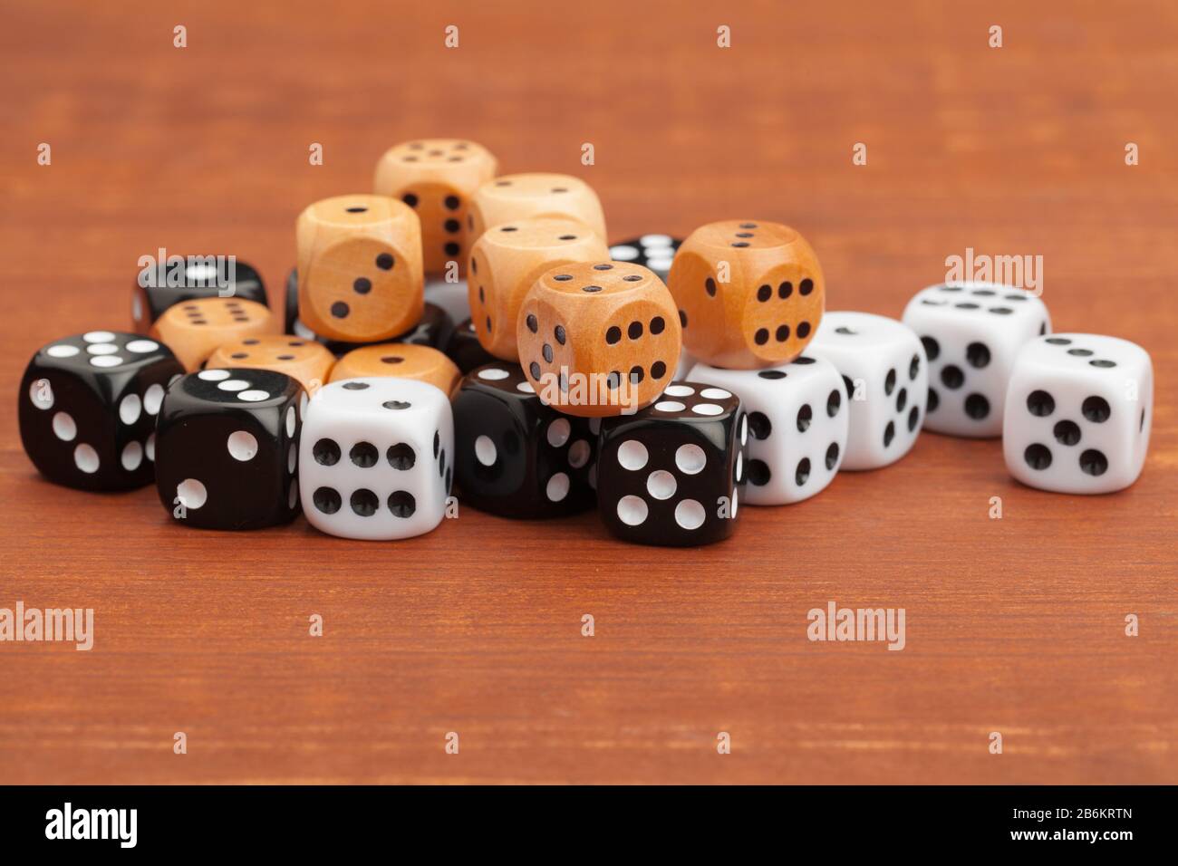 Dice on a wooden table. Concept for business risk Stock Photo - Alamy