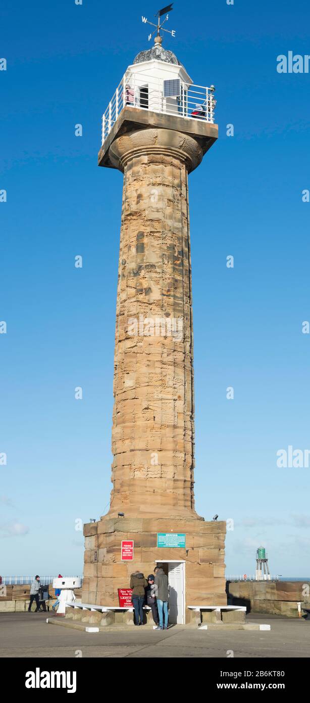 The historic lighthouse on the West pier at Whitby in North Yorkshire ...