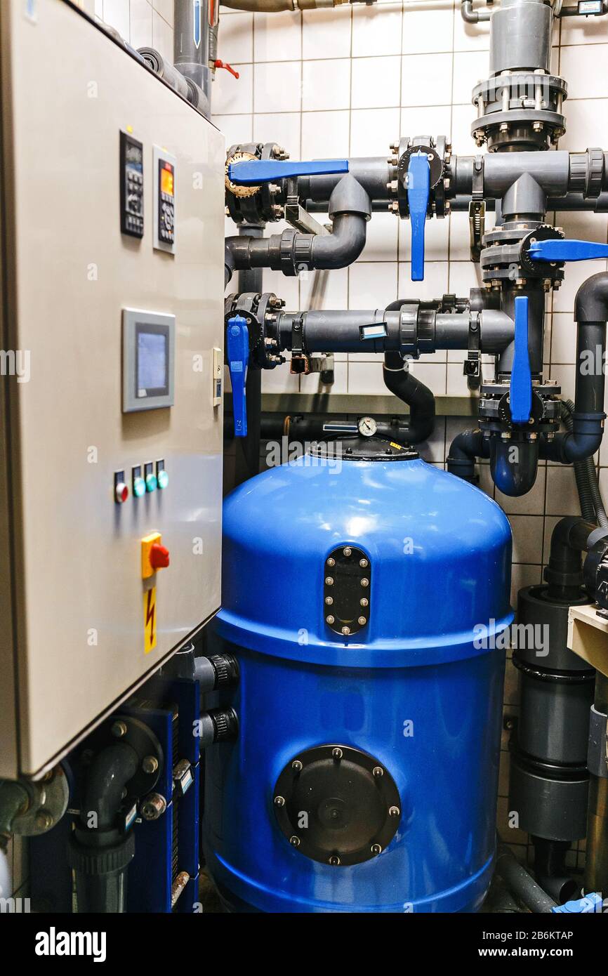 Room with plumbing equipment with pipe compressor and levers Stock ...