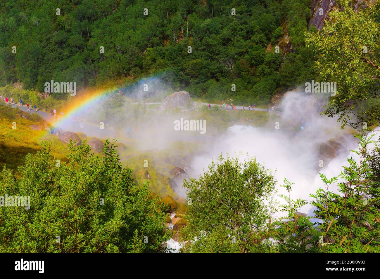Waterfall and rainbow on the way to Briksdal or Briksdalsbreen glacier ...