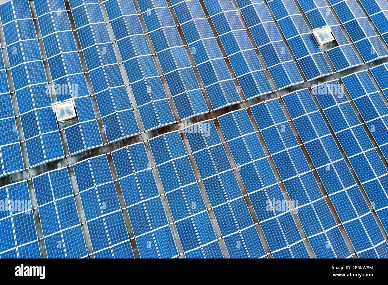 Aerial view of many photo voltaic solar panels mounted of industrial ...