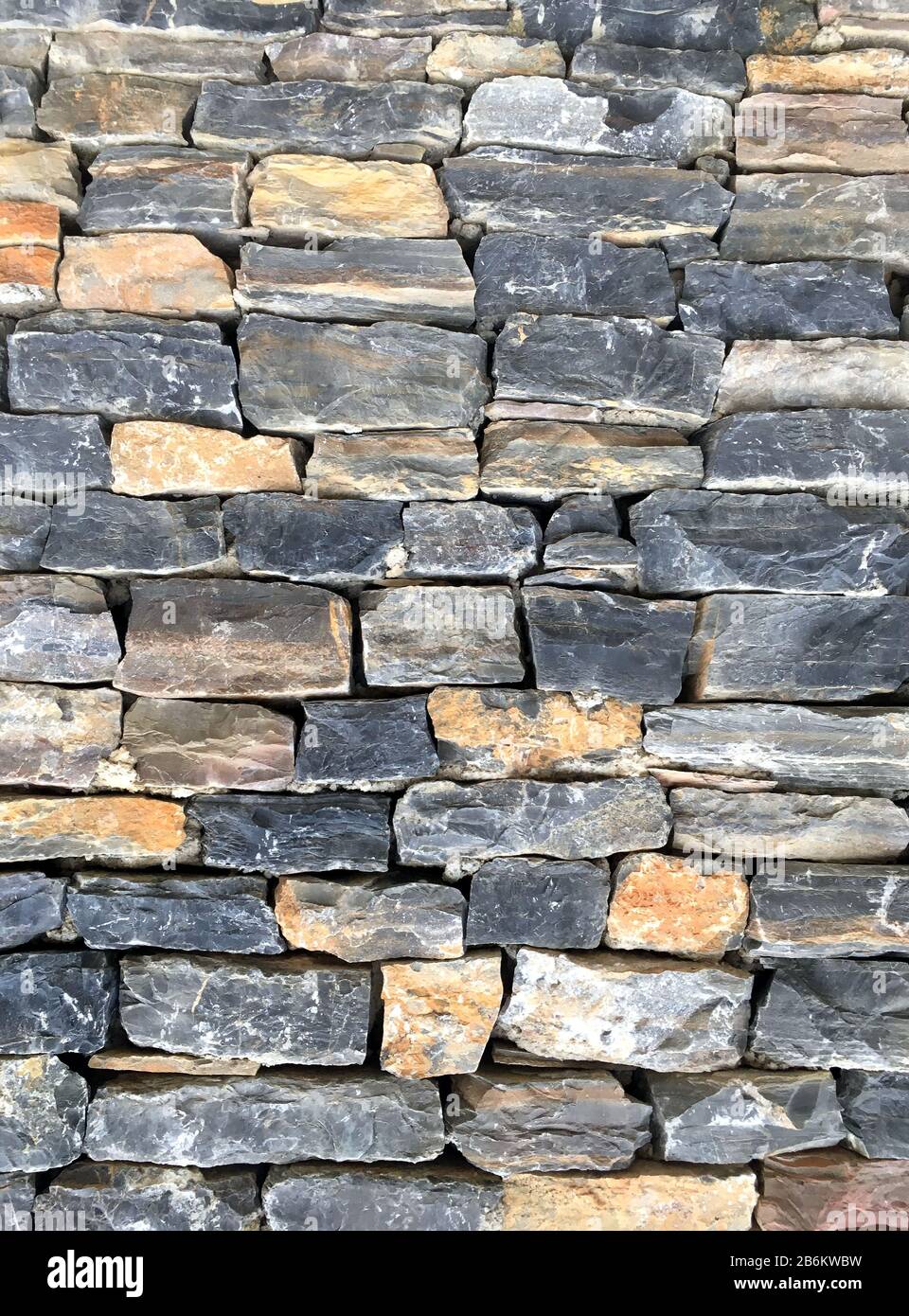 Fence stonework finishing from colorful natural stone blocks trim as ...