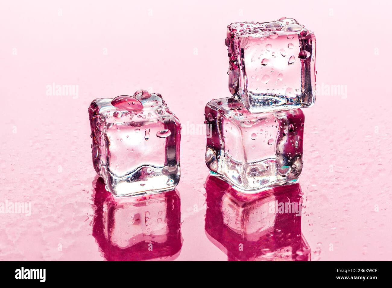 Ice cubes on pink background creative photo Stock Photo - Alamy