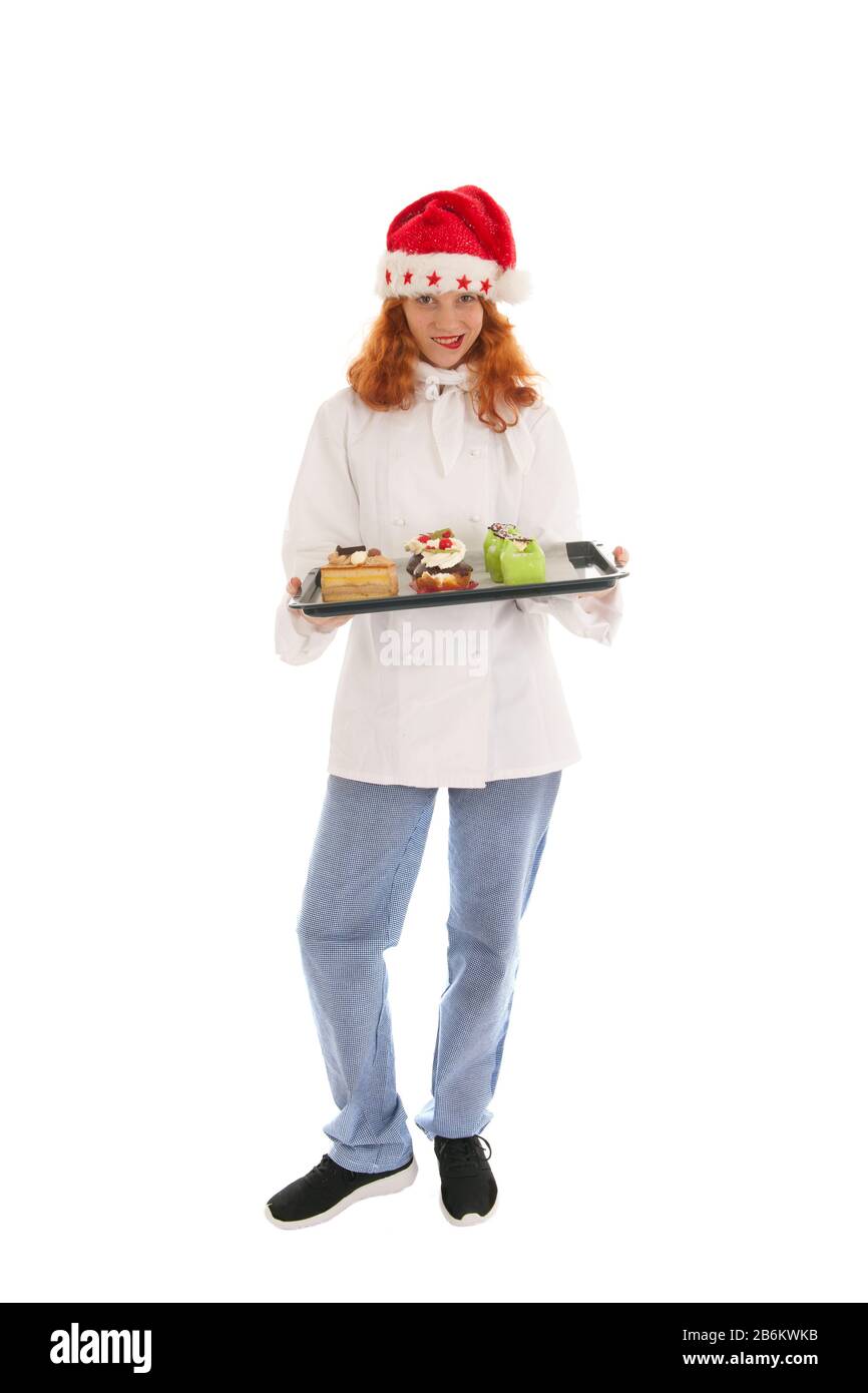 Female baker chef with red hat of Santa Claus baked Christmas pastries ...