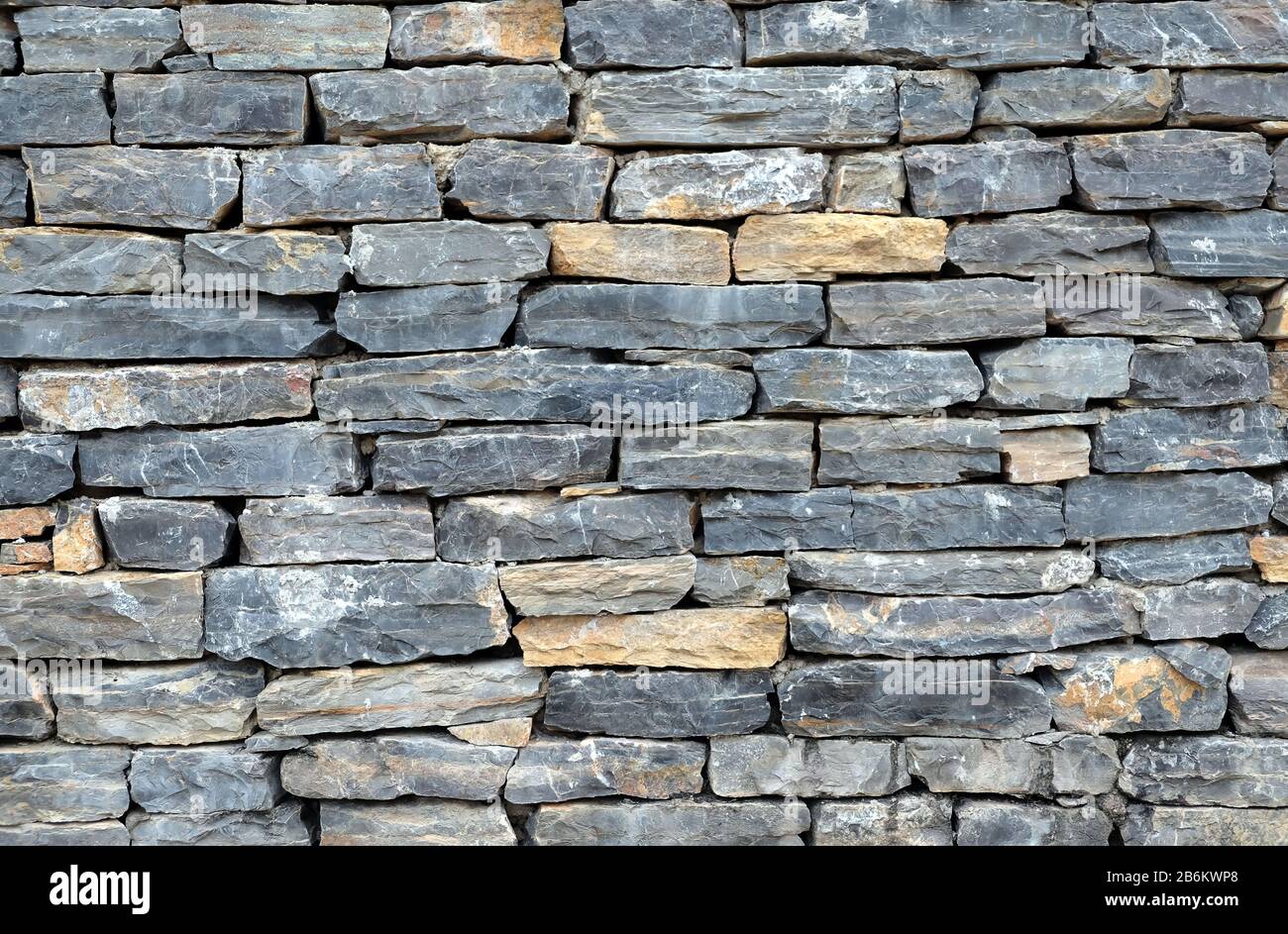 Wall stonework finishing from colorful natural stone blocks trim as ...