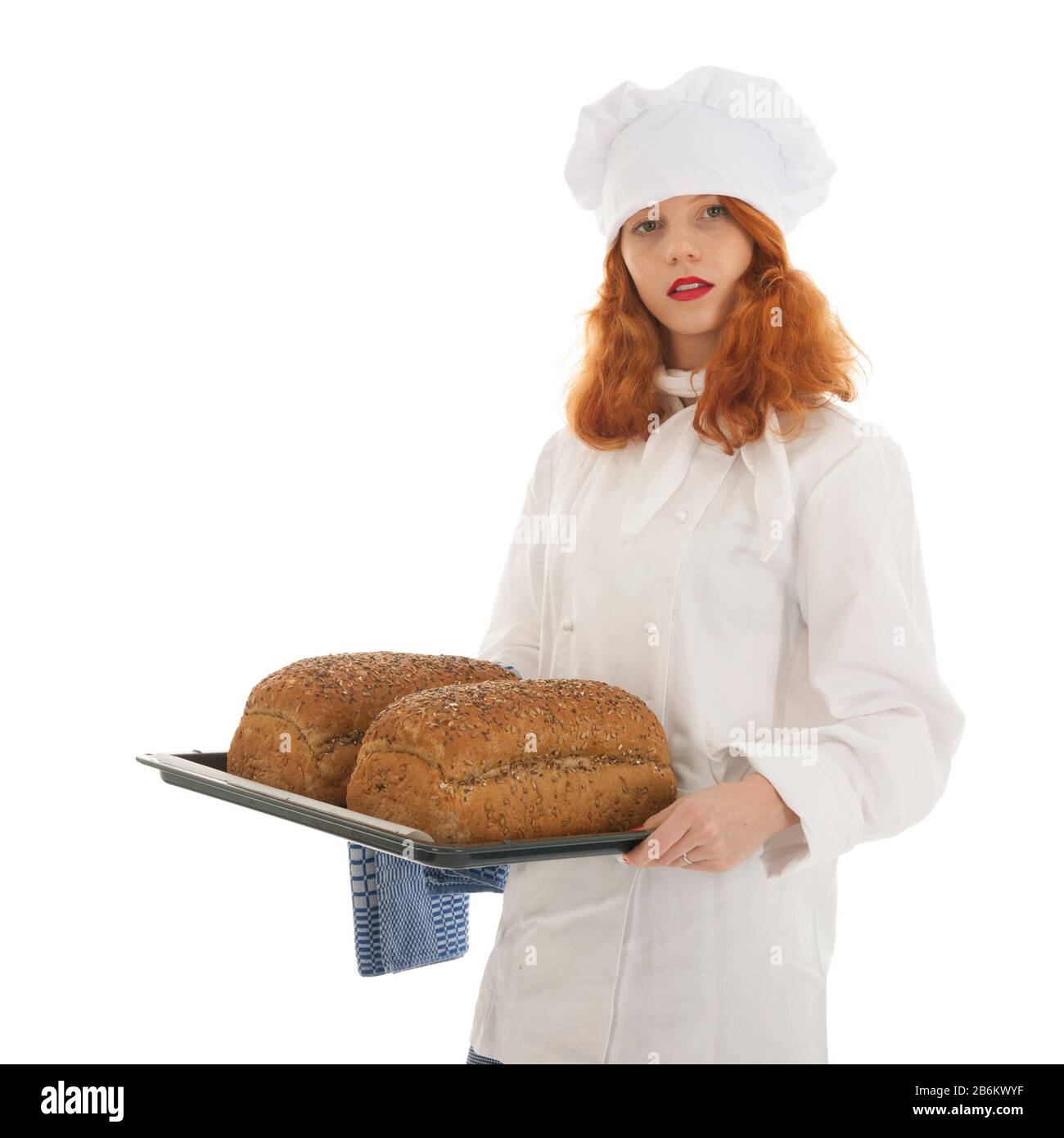 Female baker chef with red hair and baked bread isolated over white ...