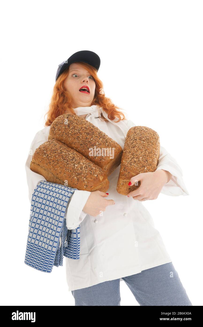Female baker chef with red hair and baked bread isolated over white ...