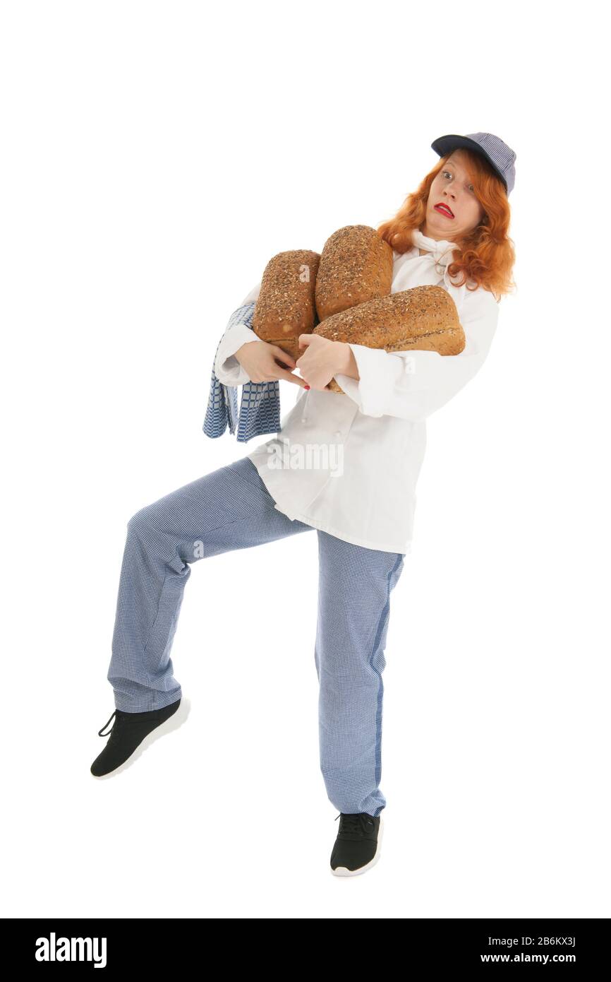 Female baker chef with red hair and baked bread isolated over white ...