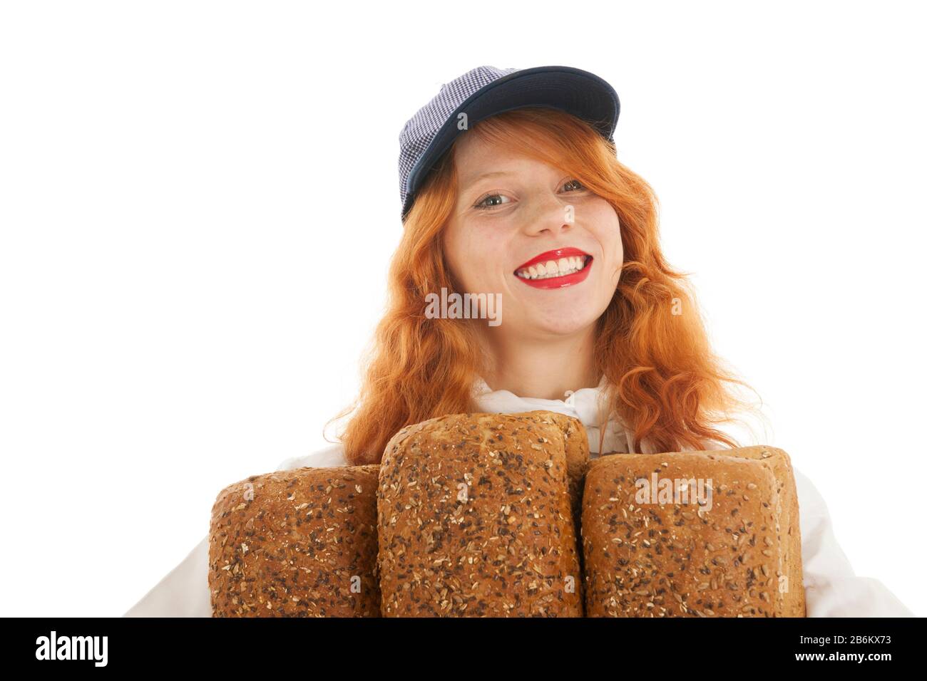 Female baker chef with red hair and baked bread isolated over white ...