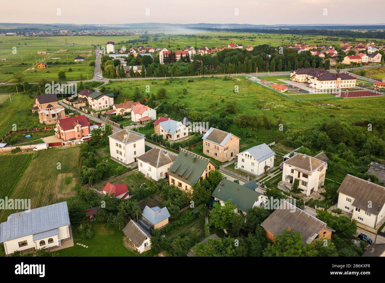 Aerial landscape of small town or village with rows of residential ...