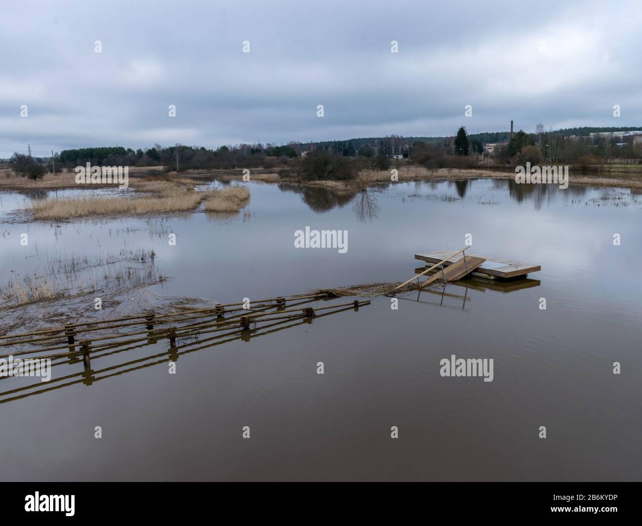 landscape with overflowing river in spring, wooden pedestrian ...