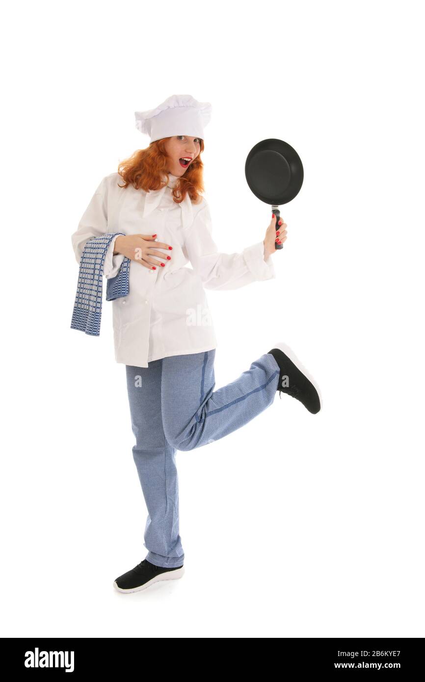 Female cook chef with red hair and frying pan dancing in studio ...