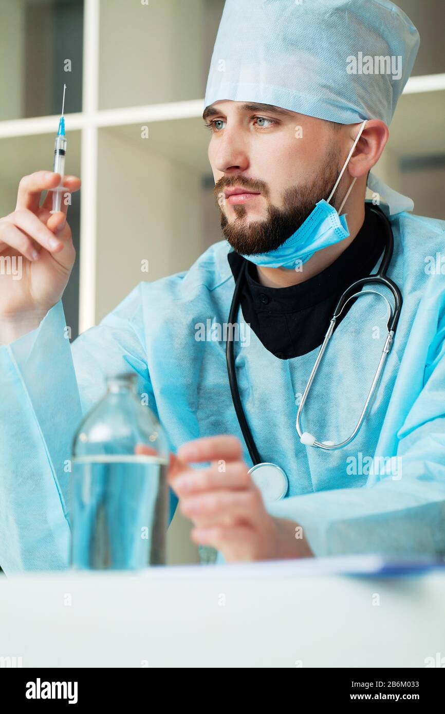 The doctor comes into a solution for injection in a syringe Stock Photo ...