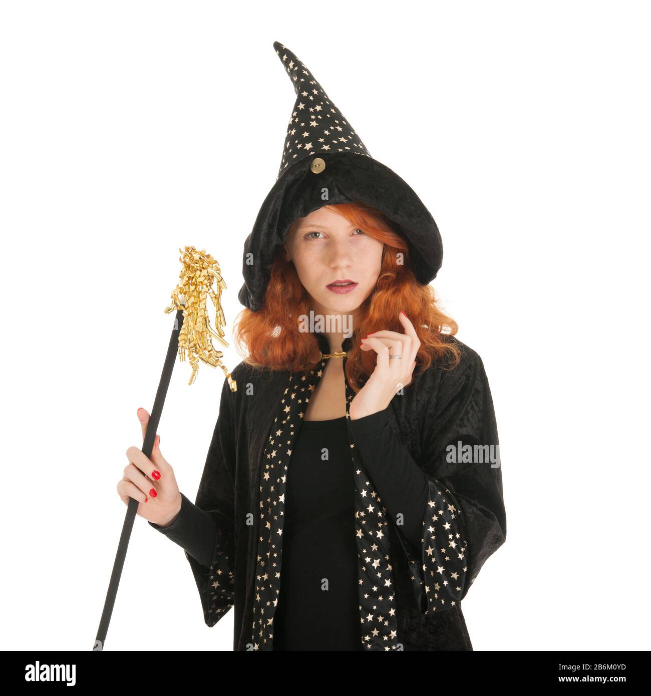 Young woman with red hair as evil witch isolated over white background ...